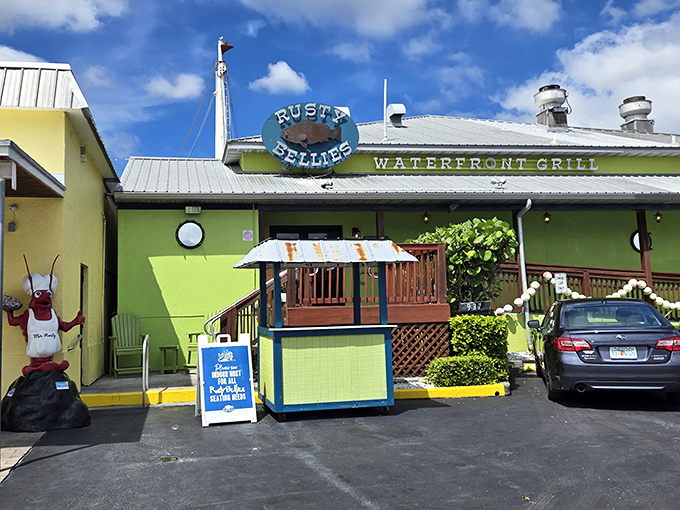 The iconic Rusty Bellies sign promises seafood paradise, while the cheerful building delivers on that promise with every plate that leaves the kitchen.