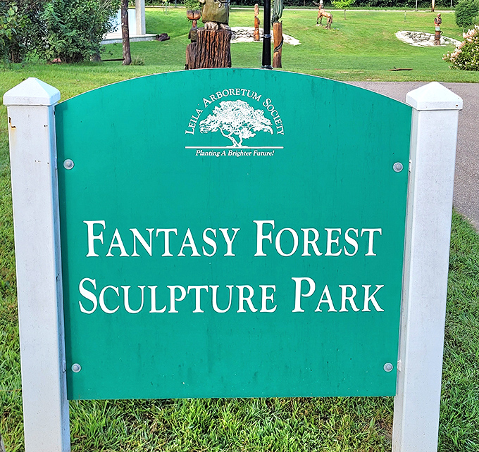 The welcoming sign marks the entrance to a world where imagination reigns and dead trees find new life as fantastical forest dwellers.