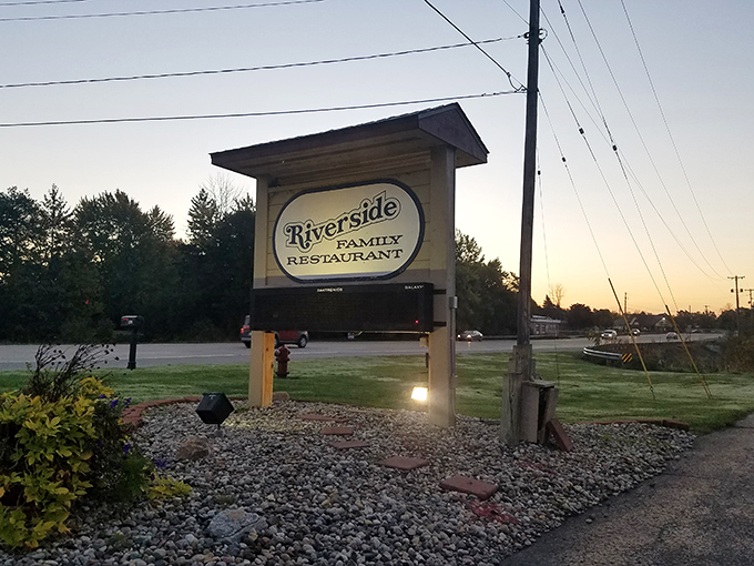 As dusk settles over Freeland, the illuminated Riverside sign beckons hungry travelers with the promise of homestyle cooking and legendary pies.