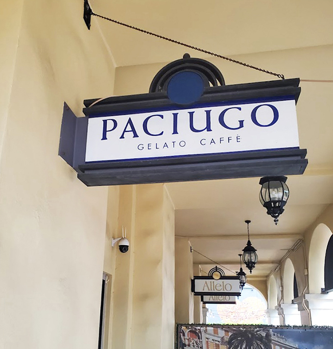 The distinctive Paciugo sign hangs proudly, marking this spot as a destination for gelato aficionados and casual sweet-seekers alike.