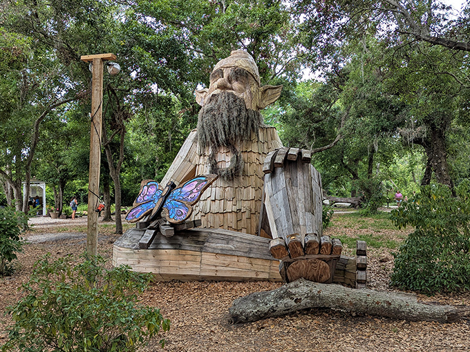 Gnomeo stands tall at Folly Farms, a 17-foot wooden guardian with an impressive beard and a butterfly friend keeping him company.