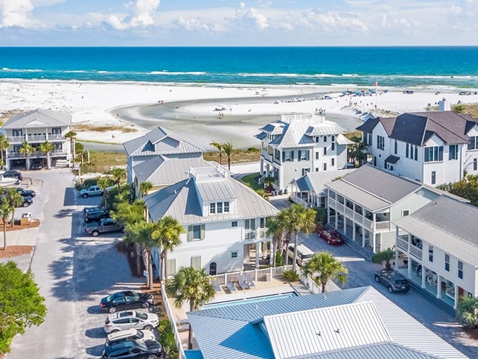 Grayton Beach's pristine shoreline stretches like a white ribbon against emerald waters, with colorful beach homes creating a perfect coastal palette.