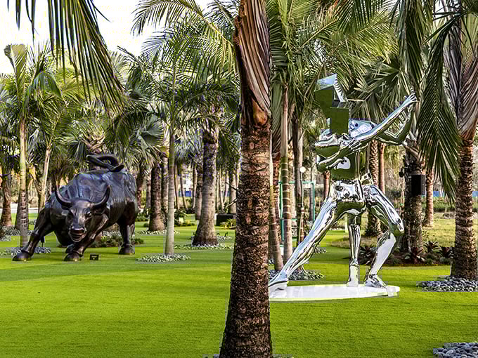 Gleaming silver figures strike dramatic poses among palm trees, while a powerful bull sculpture stands guard in Lake Nona's artistic playground.