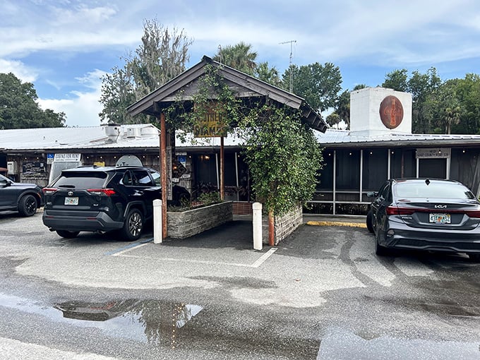 The Yearling Restaurant's rustic wooden entrance welcomes hungry travelers with old Florida charm and the promise of authentic Cracker cuisine.