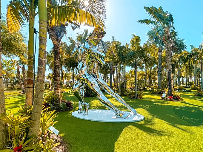 Sunlight dances across polished metal as this dynamic figure seems frozen mid-stride, surrounded by a sea of manicured green and tropical palms.