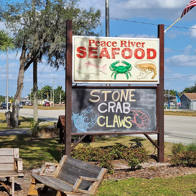 The weathered sign for Peace River Seafood promises stone crab claws that will make you forget every fancy restaurant meal you've ever had.