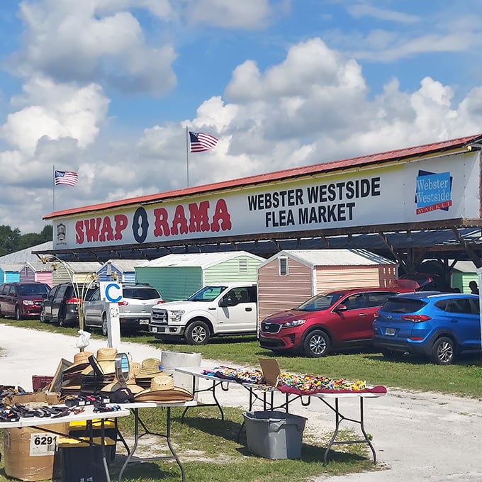 Stars, stripes, and sweet deals! The iconic "SWAP O RAMA" sign stands sentinel over Webster's marketplace, where tables overflow with sun hats perfect for flea market safaris.