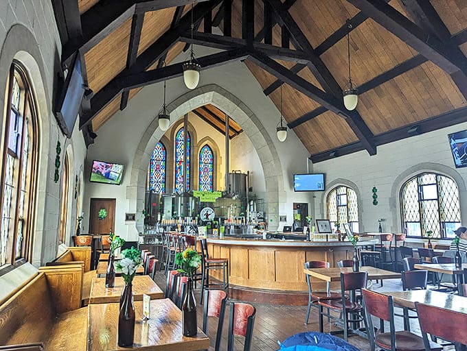 Soaring wooden beams and original stained glass windows create a reverent atmosphere where pints have replaced prayers in this breathtaking converted space.
