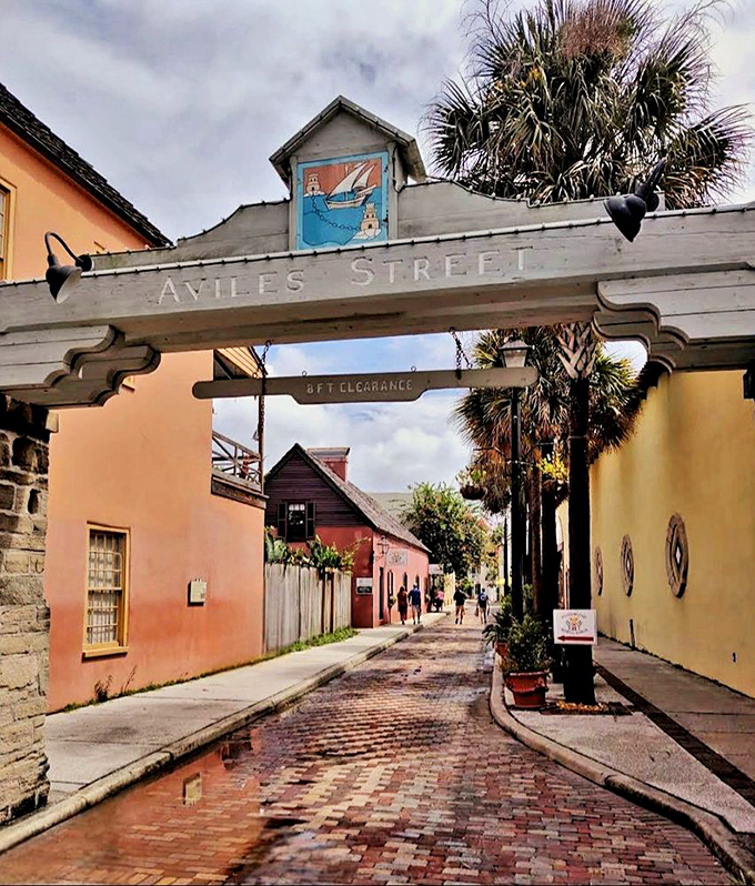 Entering Aviles Street is like walking through a time portal—with a helpful "duck if you're tall" warning!