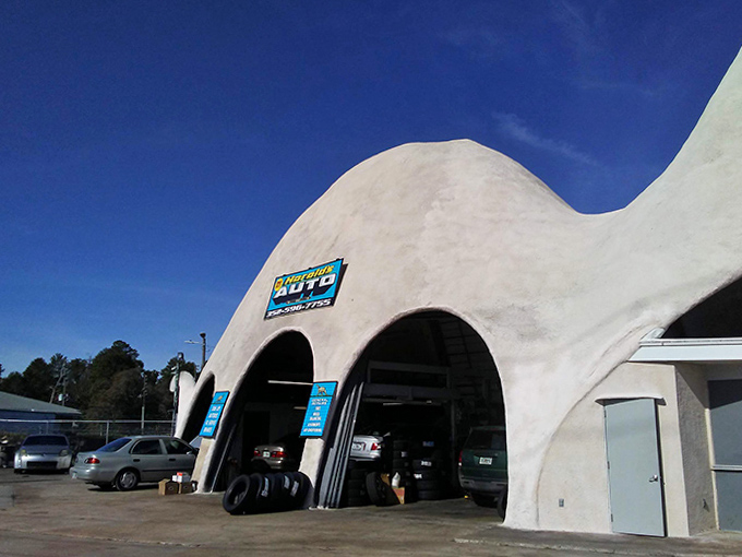The gentle curve of this concrete brontosaurus houses not fossils but fuel pumps and mechanics, blending whimsy with practicality.