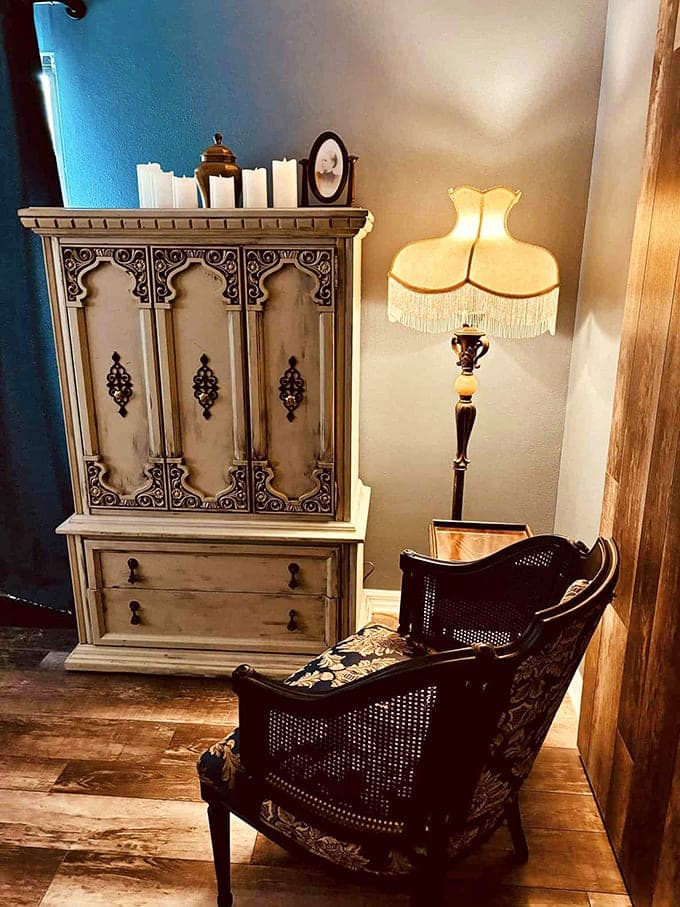 Victorian elegance meets ghostly charm in this reading nook. That antique cabinet probably has stories to tell&mdash;if you dare to listen.