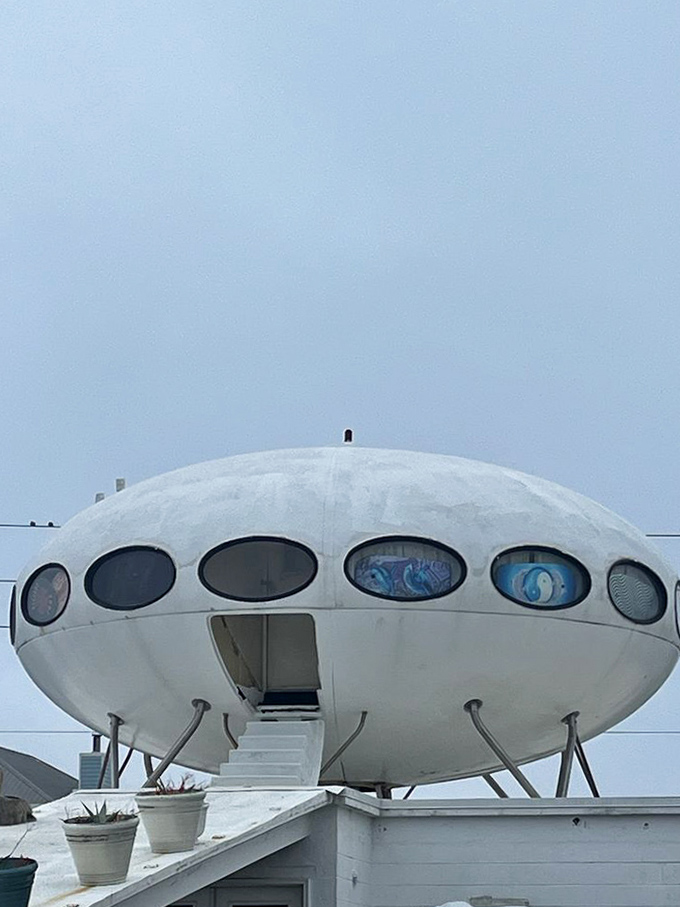 Colorful elliptical windows circle the spacecraft-like structure, offering glimpses into another dimension—or at least someone's very unique living room.
