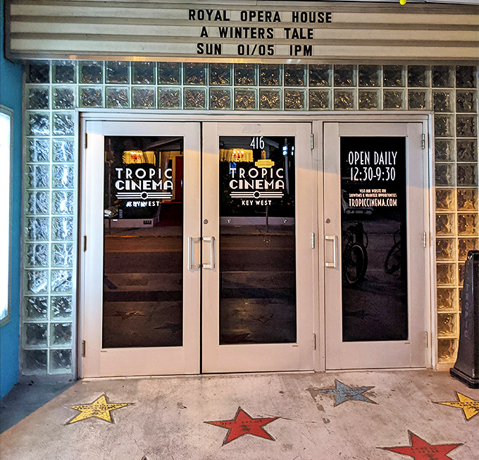 Glass block walls frame the entrance where Hollywood-style stars embedded in concrete welcome movie-goers to this cinematic paradise.