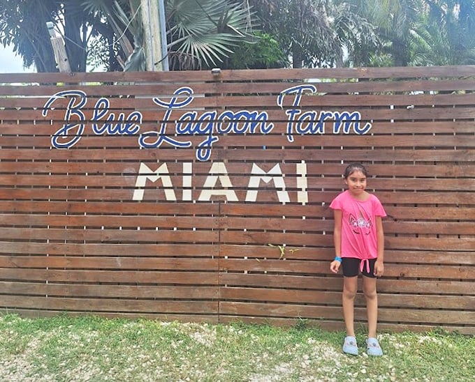 The wooden entrance sign stands as a portal between ordinary life and the aquatic wonderland that awaits beyond.