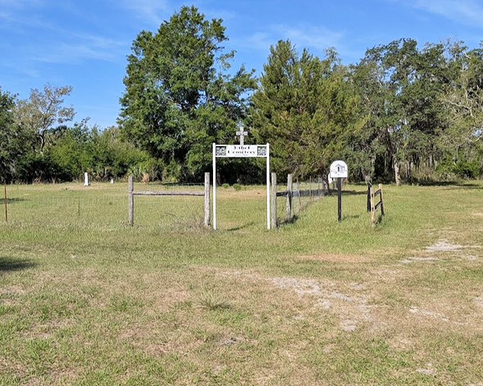 Ethel Cemetery Entrance: A humble gateway to history, where the white archway stands as a portal between centuries, inviting respectful curiosity.