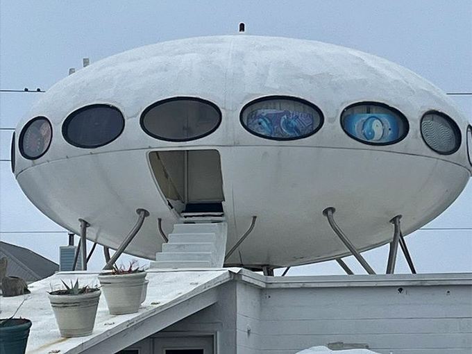 Close-up of the UFO house entrance reveals its distinctive porthole windows, like curious eyes gazing out toward the Gulf waters.