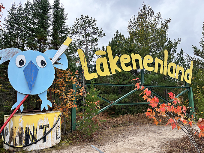 A cheerful blue bug greets visitors at another entrance point, its cartoonish eyes and vibrant color contrasting beautifully with the natural forest backdrop.