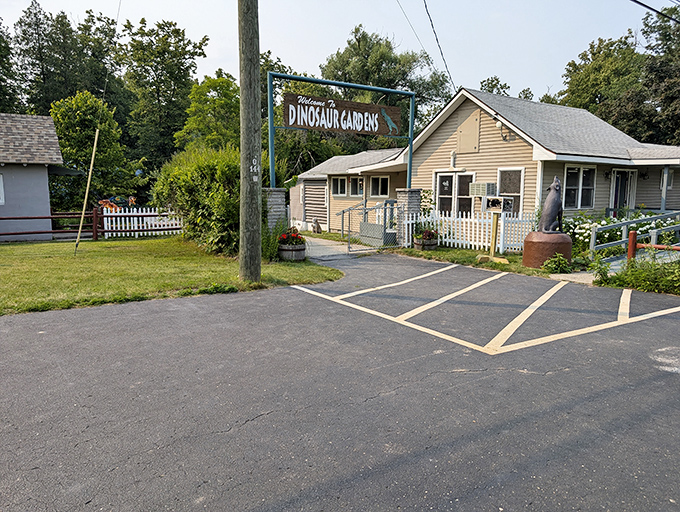 The unassuming entrance to Dinosaur Gardens belies the prehistoric wonders waiting just beyond the modest parking area.