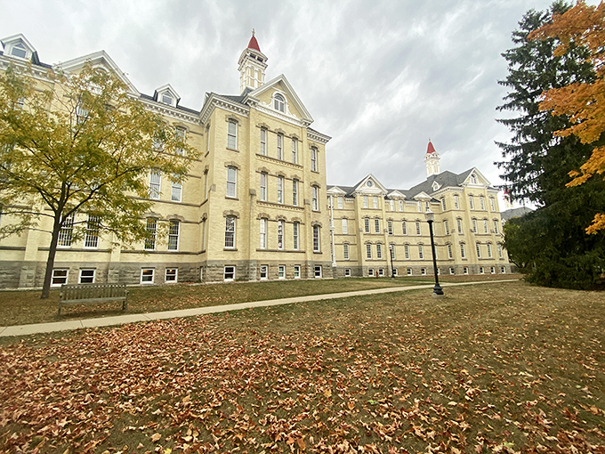 Autumn leaves frame the honey-colored brick buildings, where sunlight plays across the fa&ccedil; once represented hope for troubled minds seeking healing.