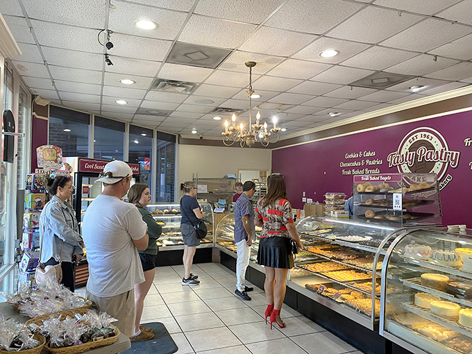 Interior: Where pastry dreams come true &ndash; customers line up beneath a chandelier, their eyes bigger than their stomachs, their resolve melting faster than buttercream.