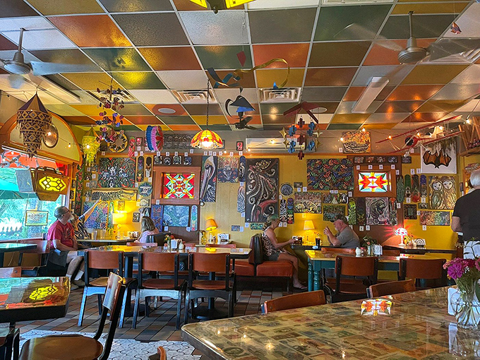 Step inside a kaleidoscope of creativity where every ceiling tile tells a story and the décor looks like it was curated by wonderfully eccentric art professors.