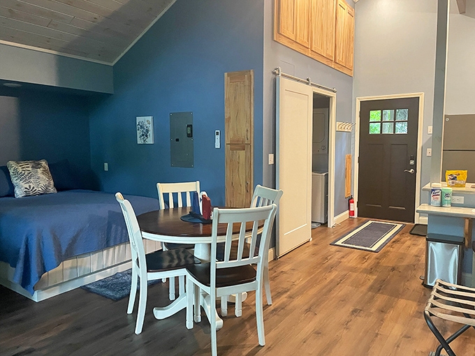 Cozy comfort meets treetop living in this thoughtfully designed interior where blue walls echo the Michigan sky visible through every window.