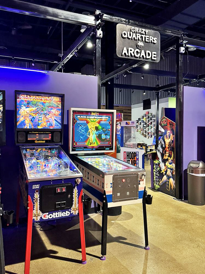 Inside Crazy Quarters, vintage pinball machines line up like old friends waiting to reconnect, their backglasses illuminating childhood memories with every flash.