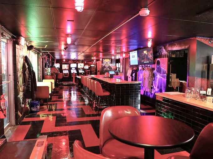 Red and black checkered floors meet crimson ceiling lights, creating a warm glow that makes every pinball wizard feel like they've finally come home.