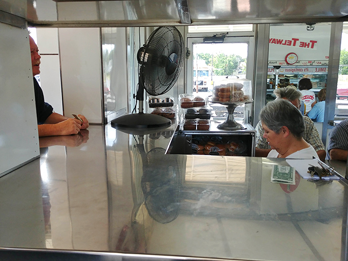 Inside, the gleaming counter invites hungry patrons to pull up a stool where conversations flow as freely as the coffee.