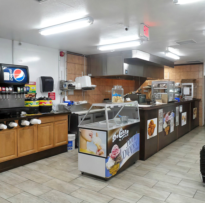 Inside, fluorescent lights illuminate a no-nonsense interior where culinary magic happens without pretense &ndash; just honest cooking and satisfied customers.