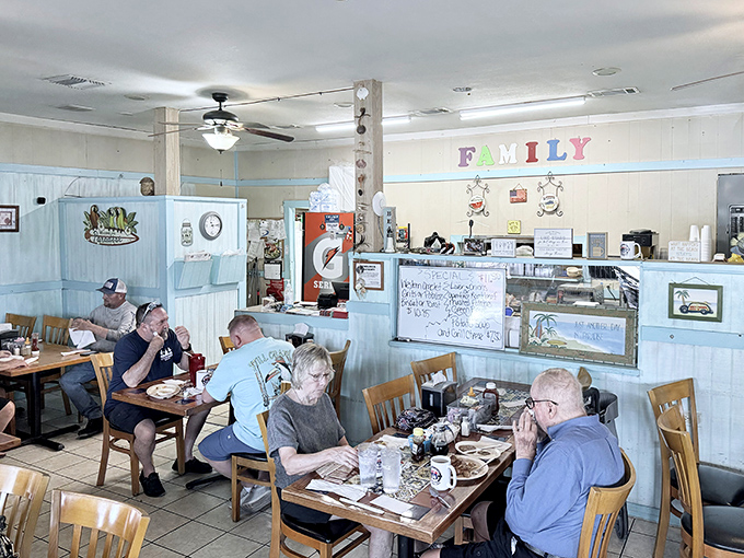 Pale blue wainscoting and wooden chairs create a homey atmosphere where conversations flow as freely as the coffee. The word "FAMILY" isn't just decor&mdash;it's the diner's entire philosophy.