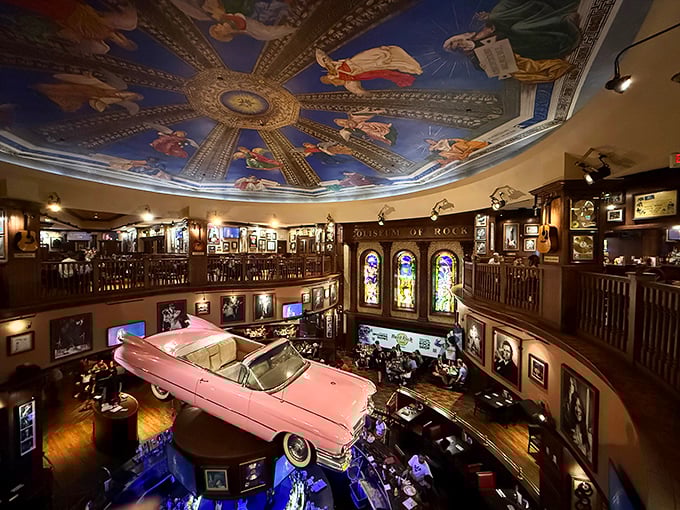 A vintage pink Cadillac suspended from the ceiling steals the show beneath a Renaissance-inspired painted dome – rock 'n' roll meets high art!