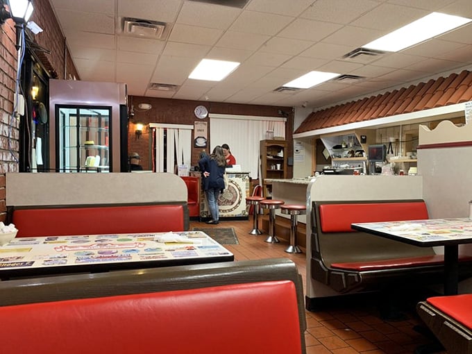 Red vinyl booths and warm lighting create that perfect diner atmosphere where calories don't count and coffee refills are practically mandatory.