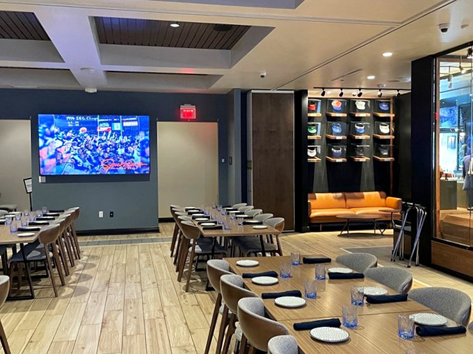 Warm wood tones and strategic lighting create the perfect balance between upscale dining and sports shrine, with comfortable seating that invites you to settle in for the big game.