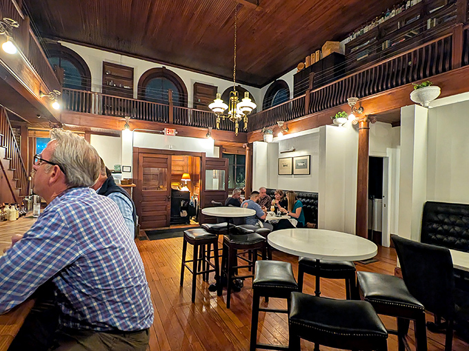 Step into yesterday: The two-story interior with its wooden balcony and warm lighting creates an atmosphere where conversations flow as smoothly as the spirits.