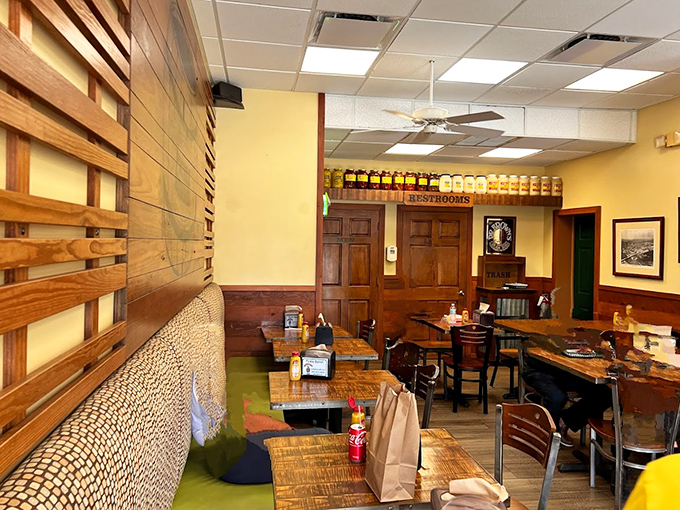 Interior: Warm wood paneling and no-nonsense tables set the stage for serious eating &ndash; this is a sandwich theater, not a fashion show.