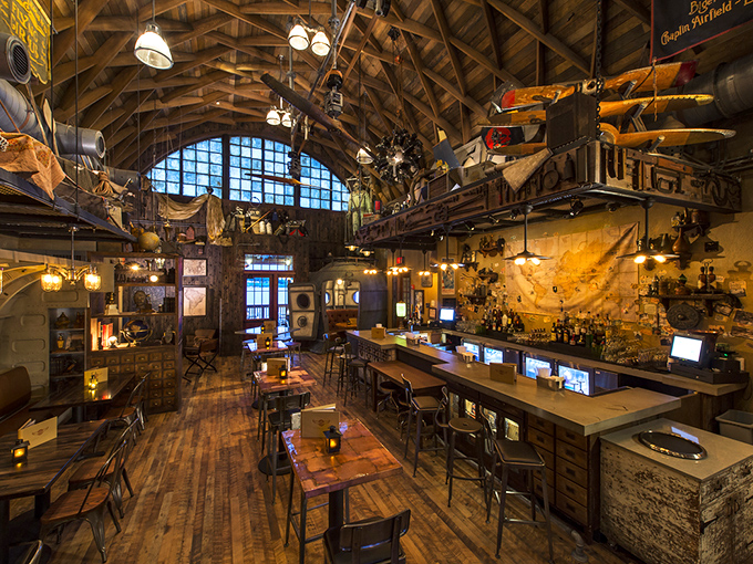 Wooden beams arch overhead like ancient ribs, while artifacts dangle from every rafter&mdash;dining under history's watchful gaze.