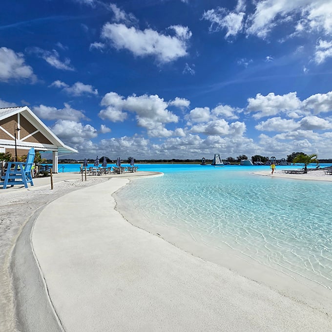 The pristine white sand beach wraps around crystal waters so clear you'll wonder if someone forgot to add the water.