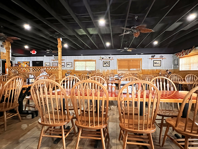 Wooden Windsor chairs and rustic tables create that "friend's backyard cookout" vibe. The dining room whispers, "Stay awhile, get comfortable, eat too much."