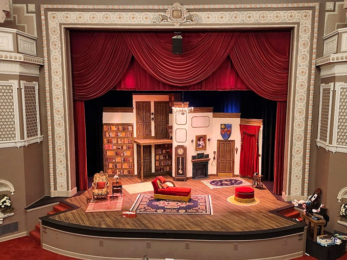 Plush red curtains frame a meticulously designed set, where countless stories have unfolded across three centuries of theatrical magic.