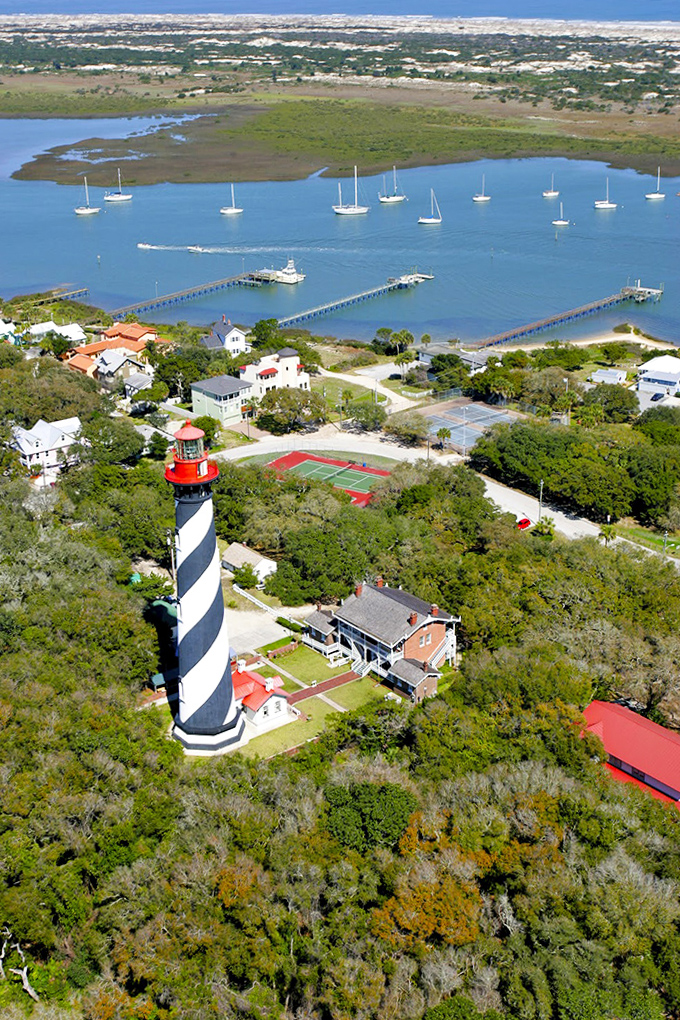 St. Augustine's iconic lighthouse stands sentinel over Matanzas Bay, its black and white spiral a navigational landmark that's been guiding mariners home since 1874.