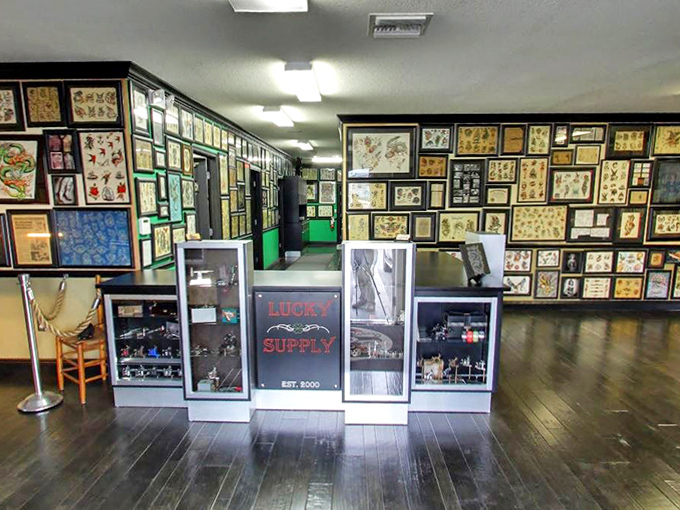 Wall-to-wall tattoo flash art creates an immersive experience, showcasing decades of American tattoo design evolution.