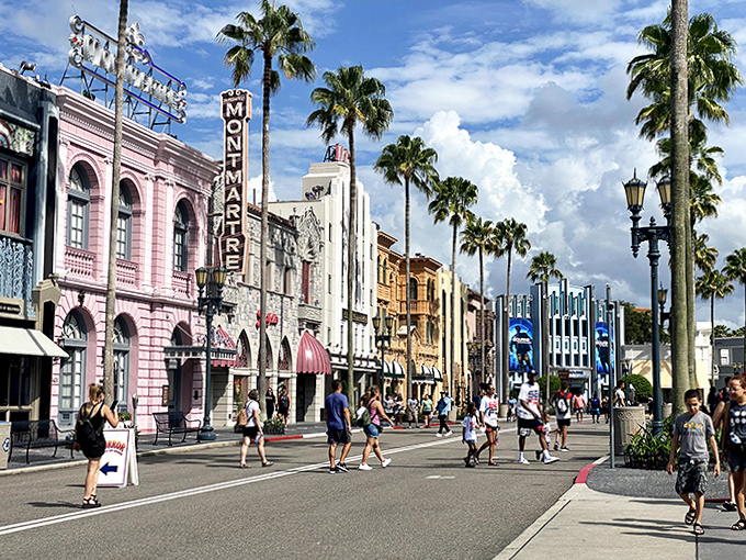 Step into movie magic on this bustling street where every storefront tells a story and palm trees frame the perfect Florida theme park day.
