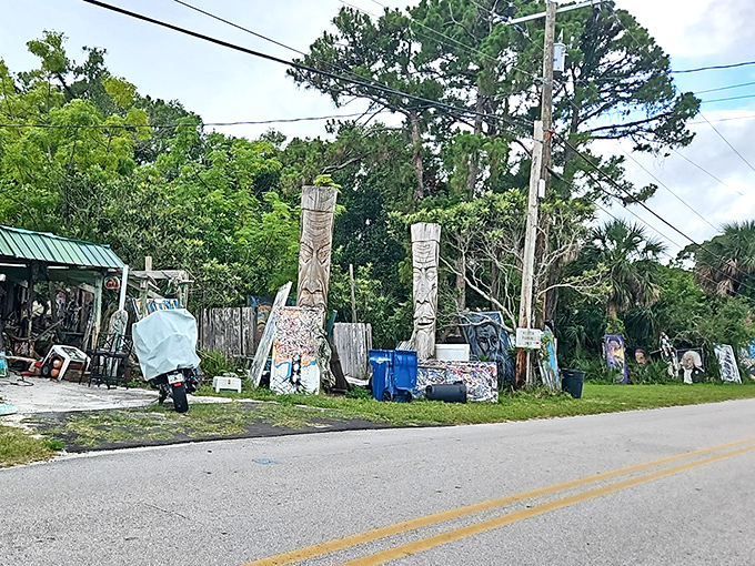 The roadside gallery reveals itself unexpectedly, wooden totems rising from the earth like ancient guardians of forgotten stories.