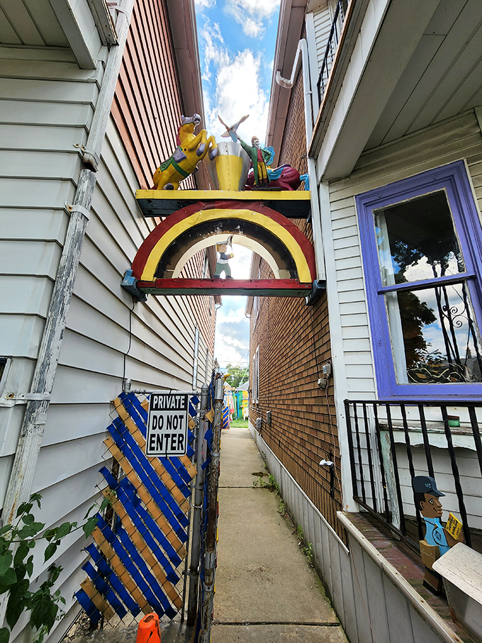 The narrow alleyway serves as a portal between ordinary life and extraordinary imagination, inviting curious visitors into another world.