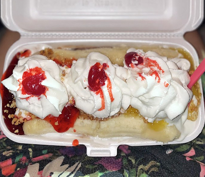 This banana split isn't just dessert—it's an architectural marvel of creamy scoops, fresh fruit, and rivers of toppings that would make any sweet tooth surrender unconditionally.