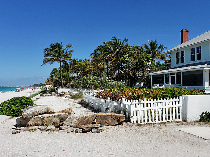 Charming beachfront cottages stand sentinel along Boca Grande's shore, their white picket fences framing postcard-perfect views of paradise.