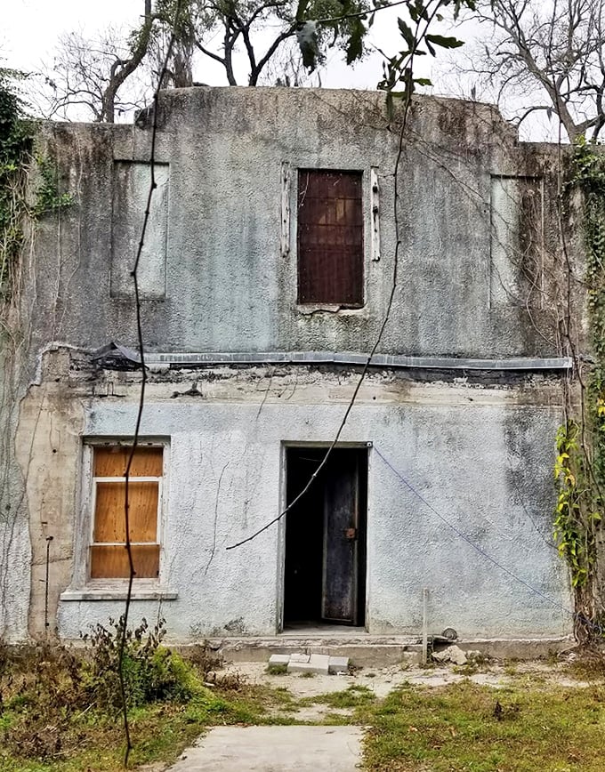The stark two-story structure stands as a silent sentinel to justice from another era, its weathered fa&ccedil;ade telling stories without saying a word.