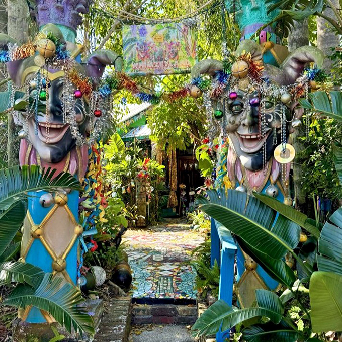 Jester guardians flank the entrance to Whimzeyland, their beaded faces forever grinning as they welcome visitors to this artistic wonderland.