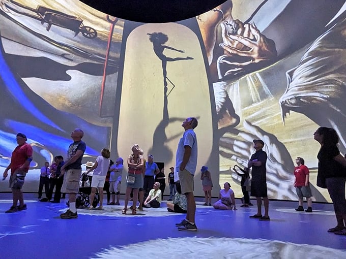 The immersive experience transforms viewers into participants as surrealist visions envelop the space, making everyone part of Dal&iacute;'s fantastical world.
